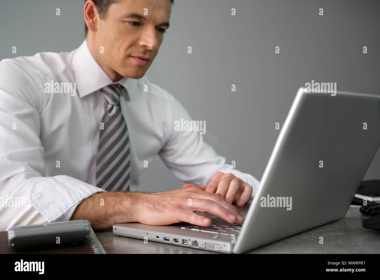 Man working away at his desk Stock Photo - Alamy