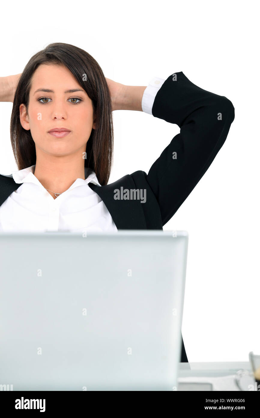 Woman leaning back from her laptop computer Stock Photo - Alamy
