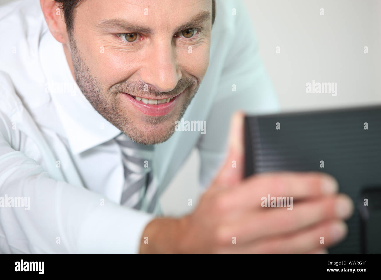 Man adjusting screen Stock Photo - Alamy