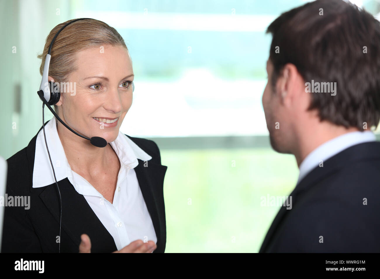 Woman informing man Stock Photo - Alamy