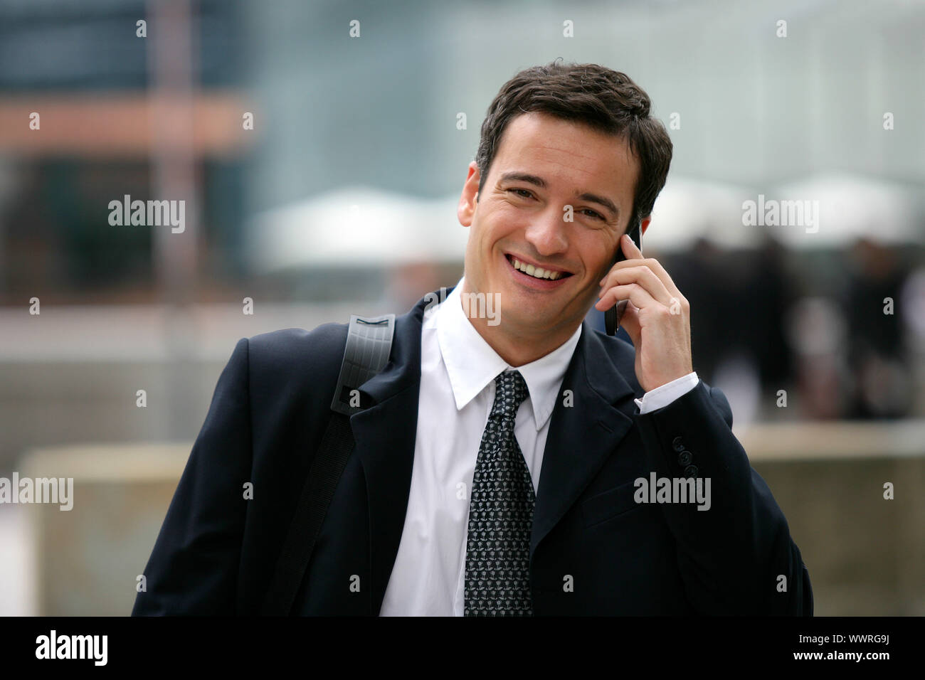 Smiling commuter on the phone Stock Photo - Alamy