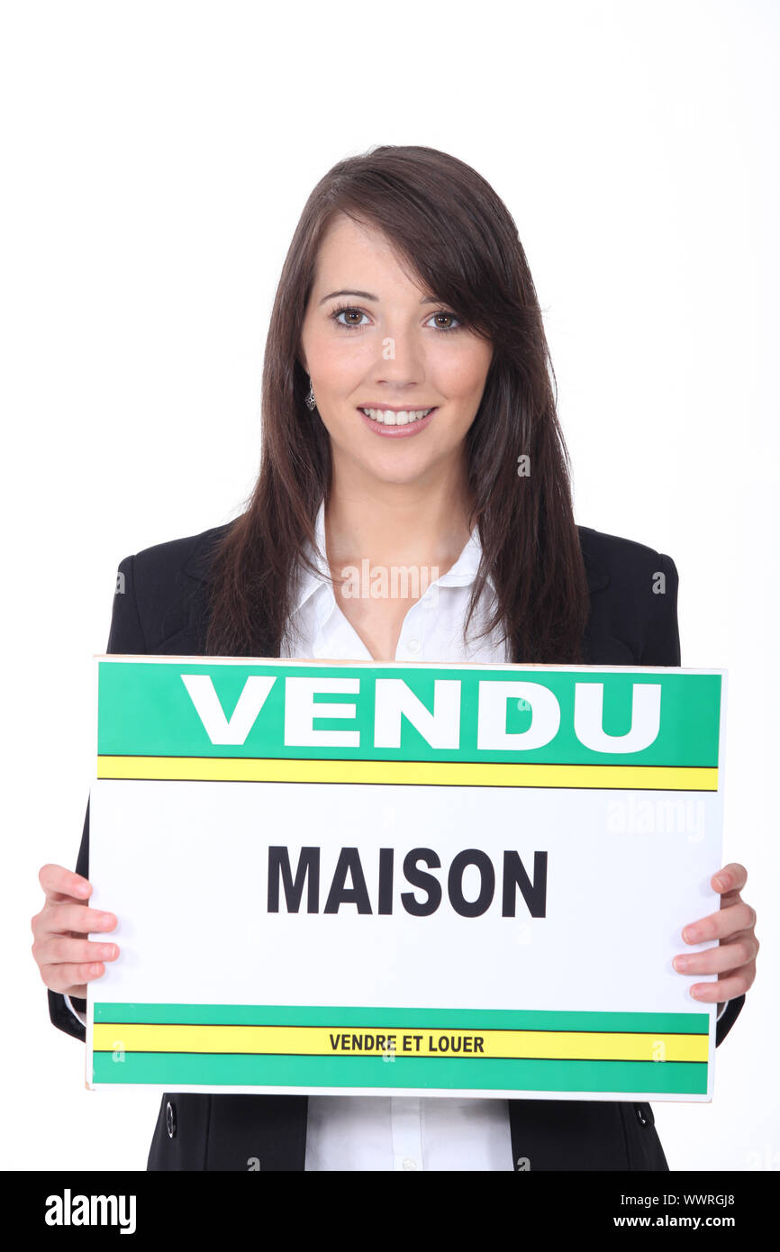Estate agent holding sold sign Stock Photo - Alamy