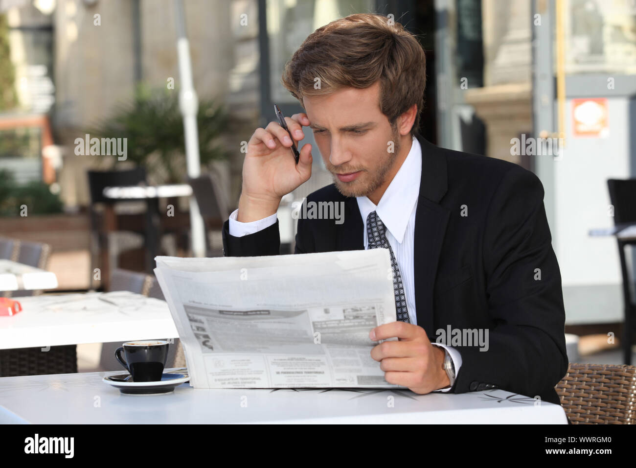 Man with newspaper and coffee Stock Photo - Alamy