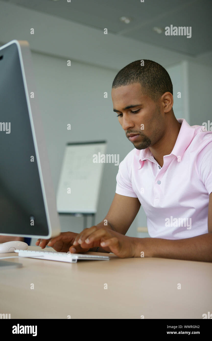 Man typing at computer Stock Photo - Alamy