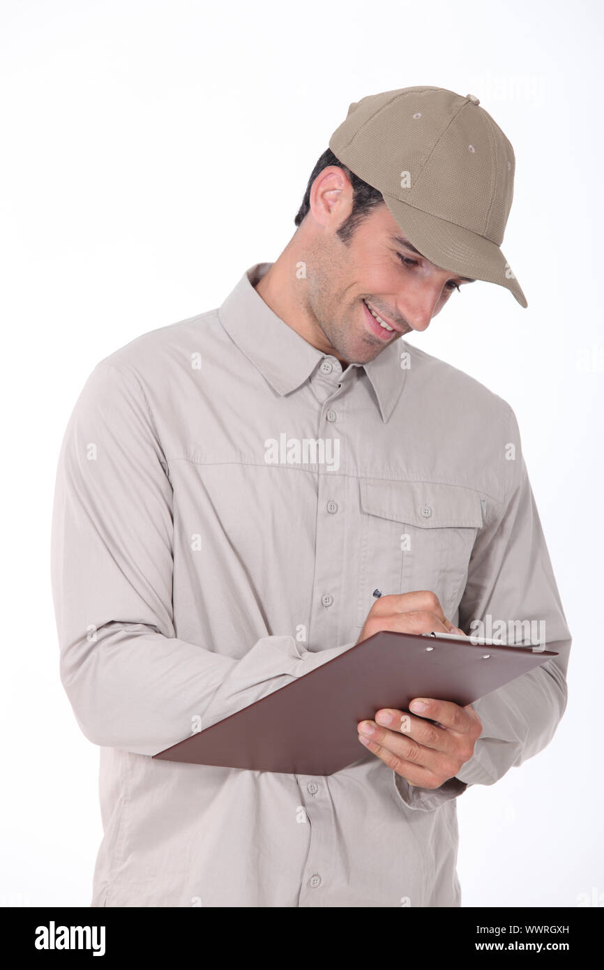 Delivery worker checking clipboard Stock Photo - Alamy