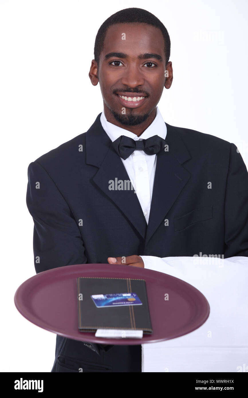 Smart waiter with the bill and a credit card Stock Photo - Alamy