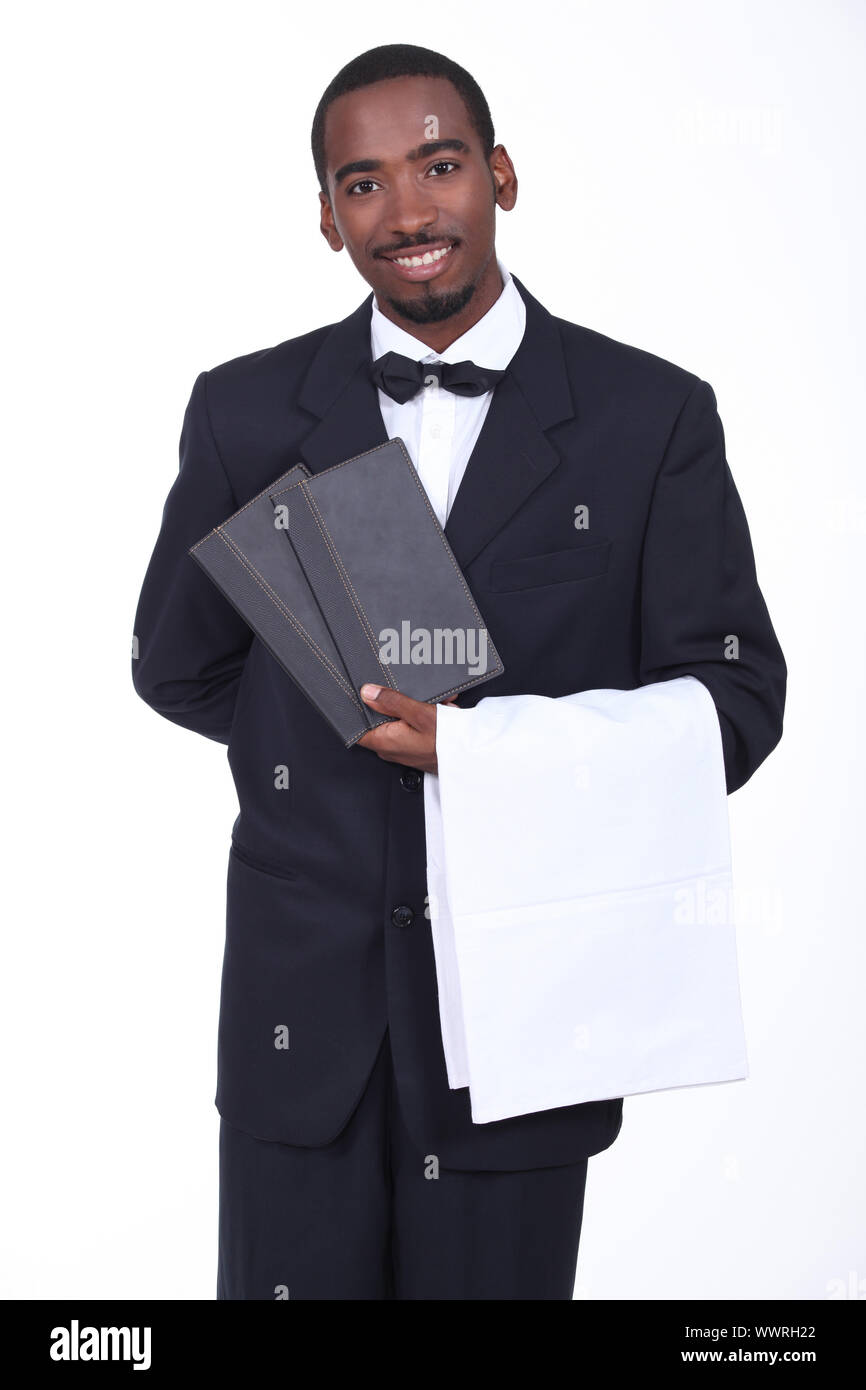 Waiter showing menus Stock Photo - Alamy