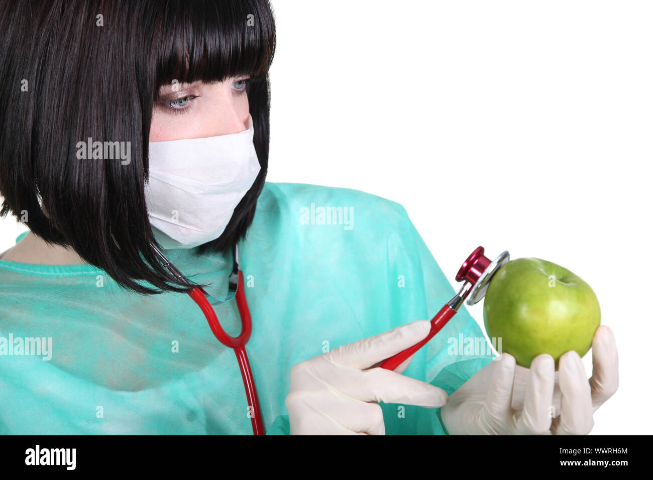 Female medic checking the pulse of an apple Stock Photo - Alamy