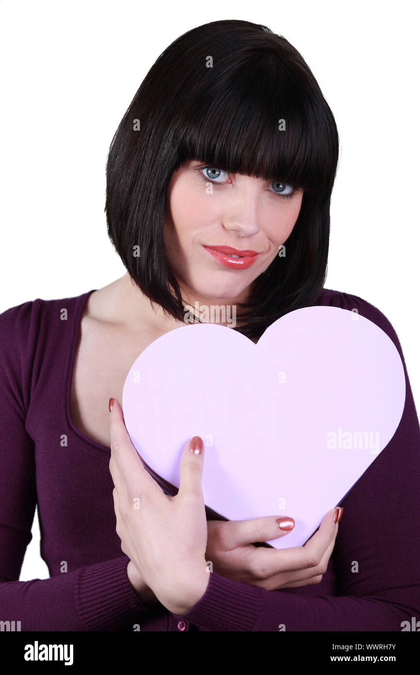 a brunette woman with a heart shaped box Stock Photo - Alamy