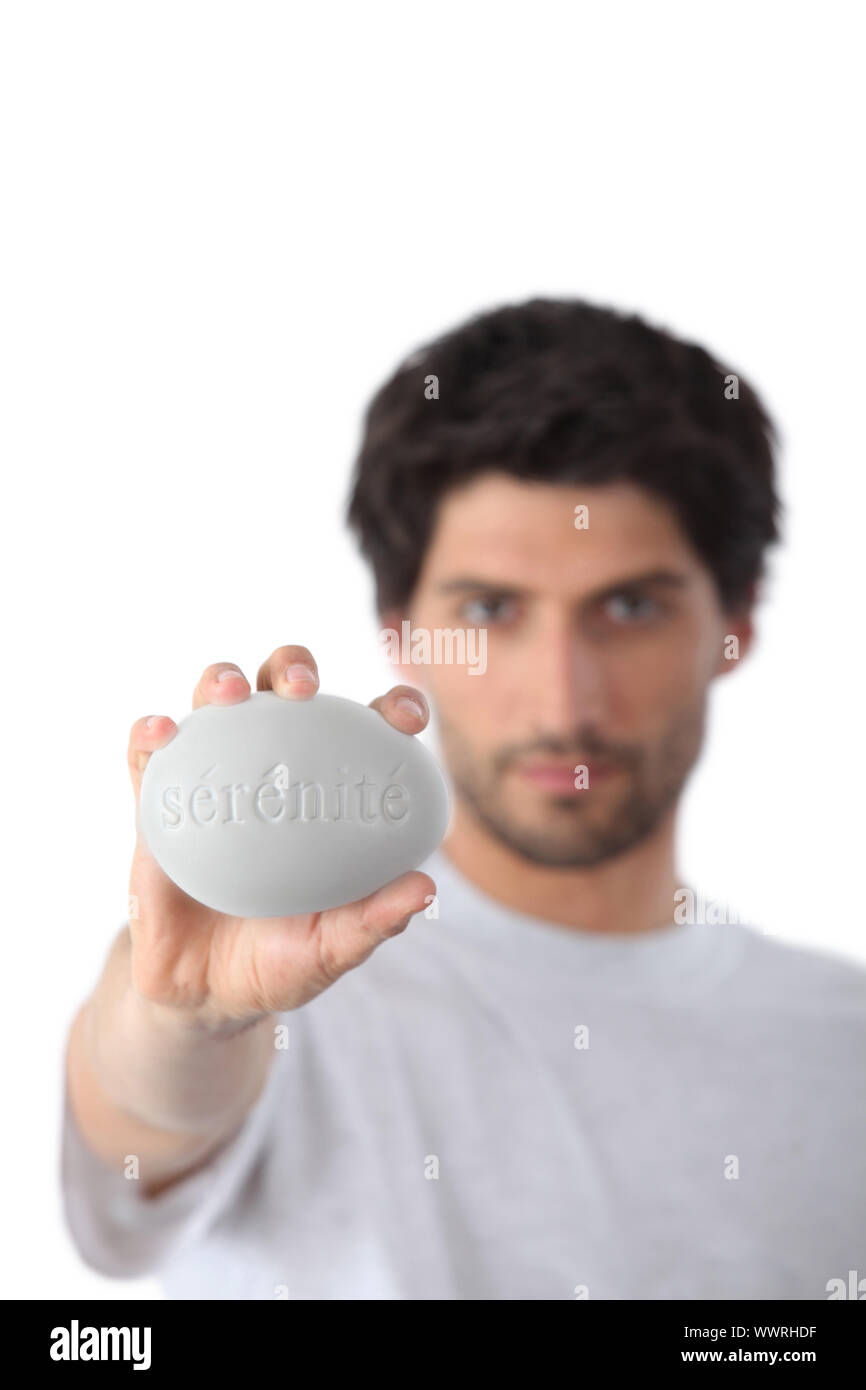 Man holding a bar of soap Stock Photo - Alamy