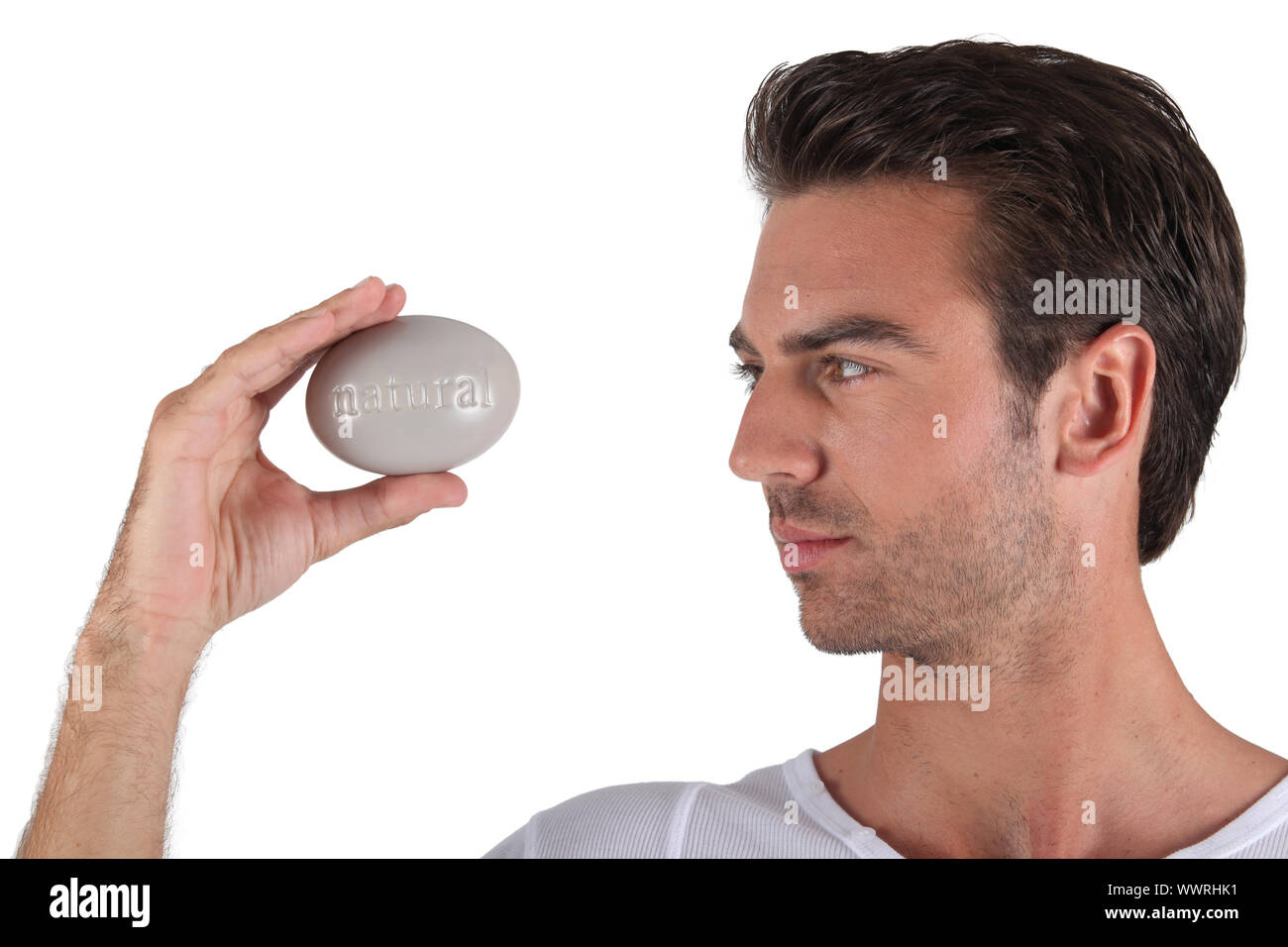 Man holding pebble in hand Stock Photo - Alamy