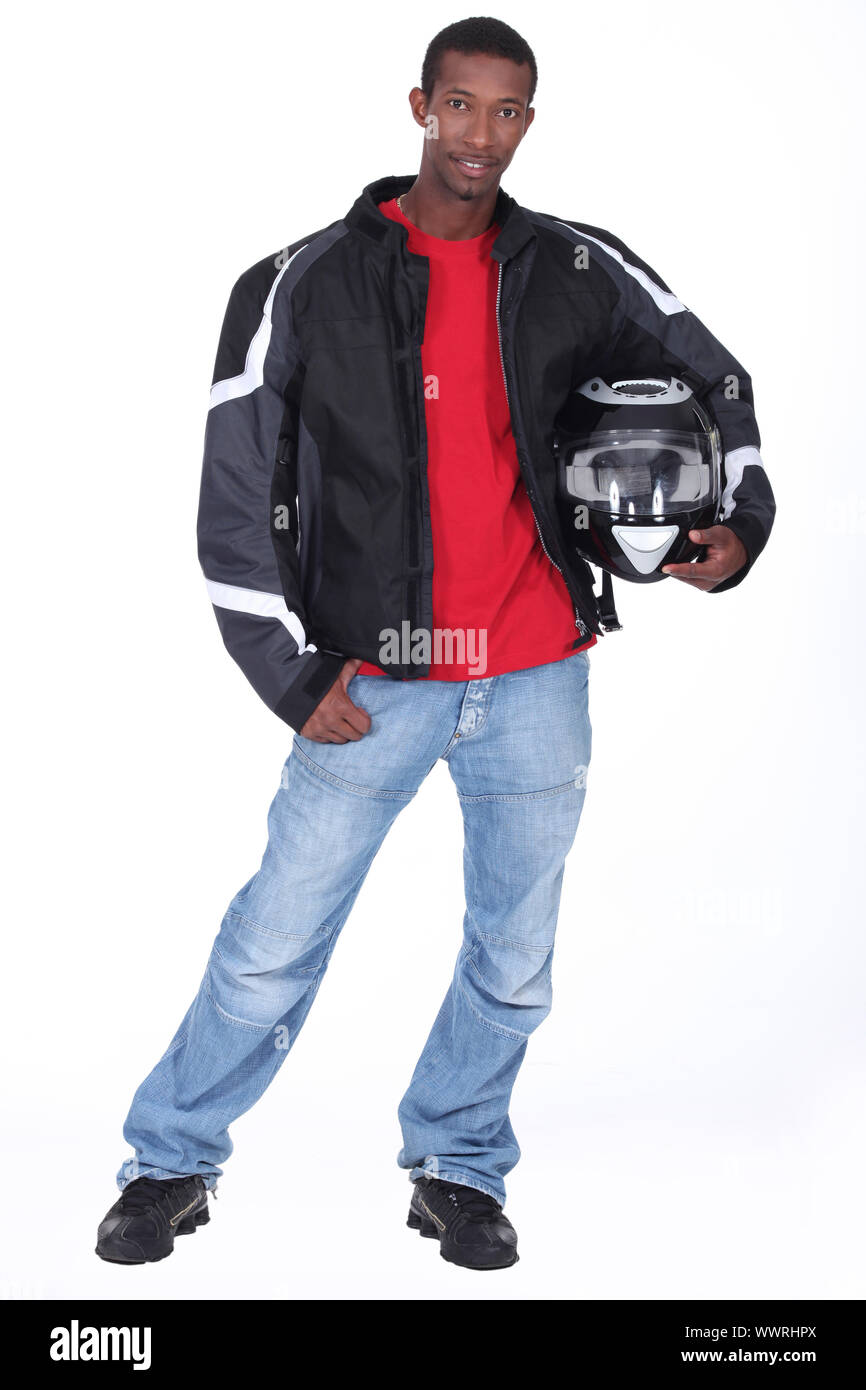 Biker stood holding helmet Stock Photo - Alamy