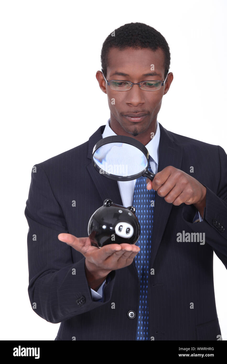 Man observing a piggy bank Stock Photo - Alamy