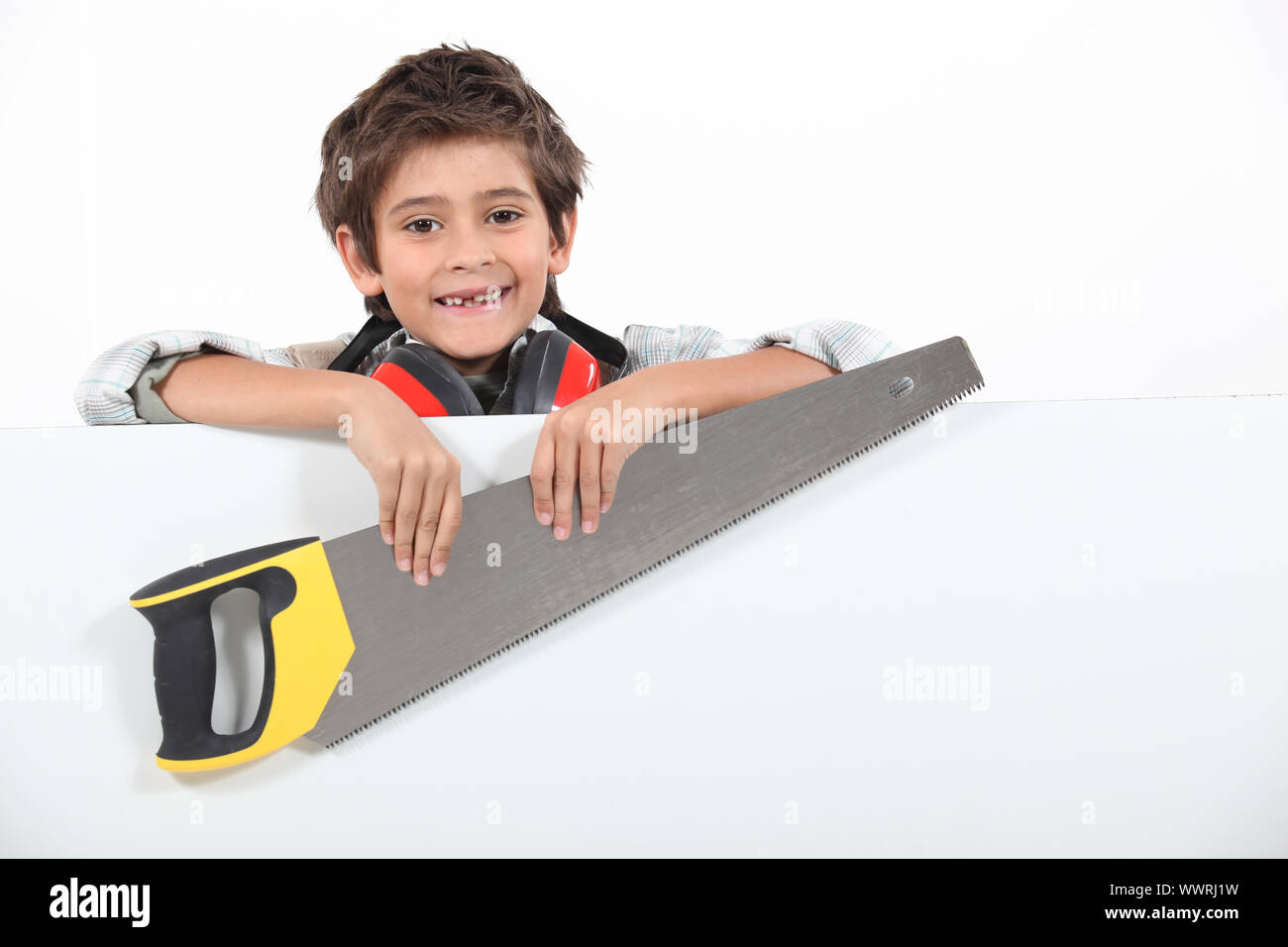Little boy holding a saw on white background Stock Photo - Alamy