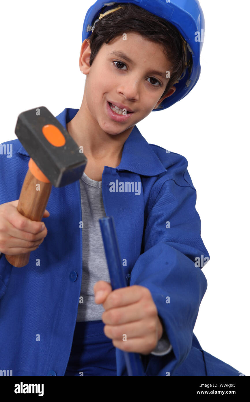 A kid dressed as a construction worker with a hammer Stock Photo - Alamy