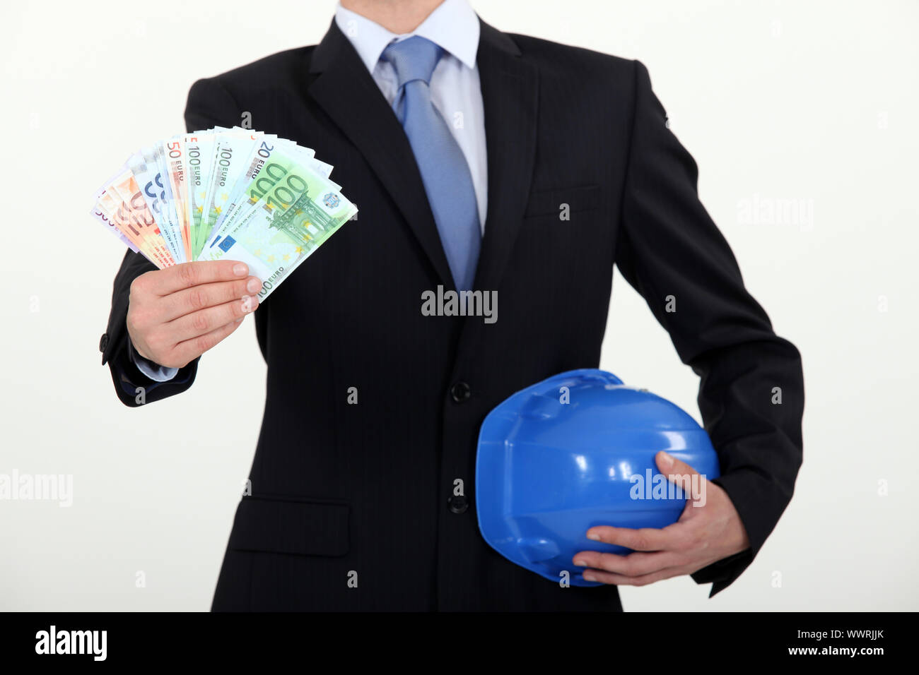 Architect holding banknotes Stock Photo - Alamy