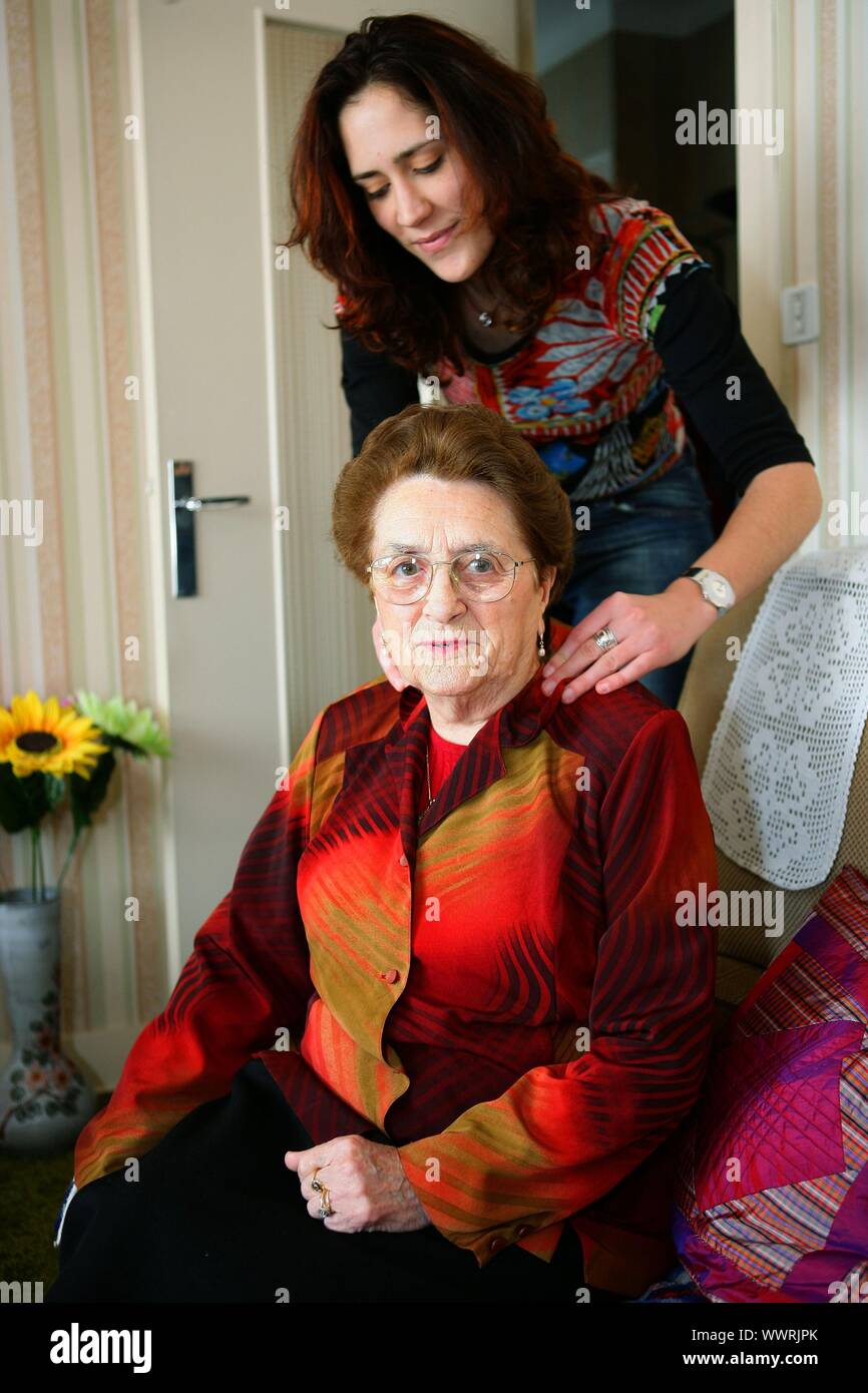 Woman helping old lady Stock Photo - Alamy
