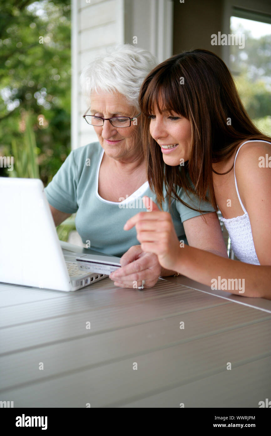Mother and daughter using laptop Stock Photo - Alamy