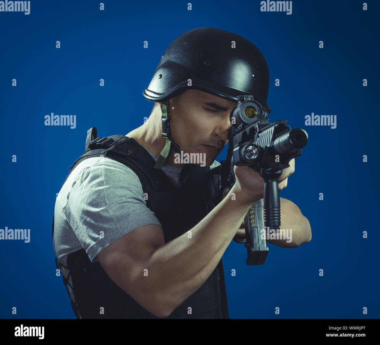 Security, paintball sport player wearing protective helmet aiming ...