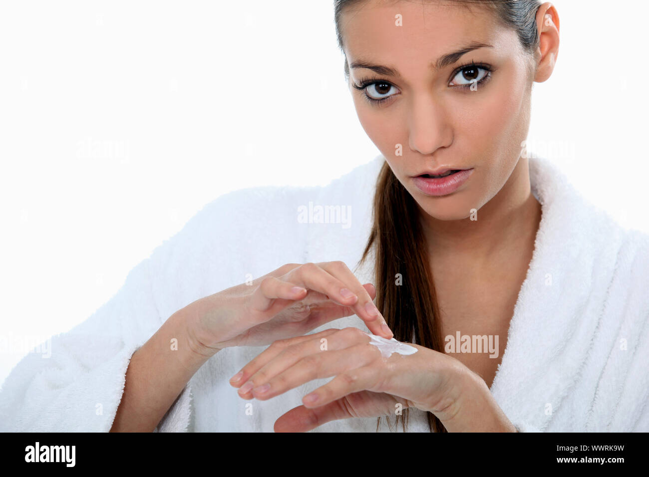 Attractive woman applying skin cream Stock Photo - Alamy