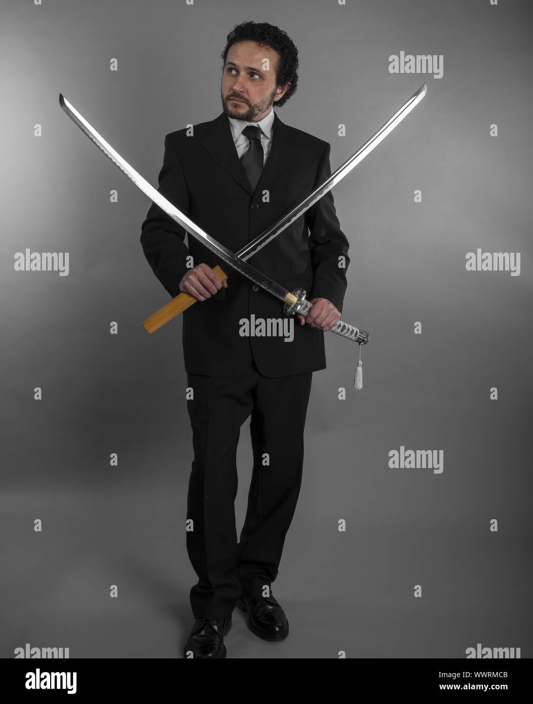 Aggressive businessman with Japanese swords in defensive and defensive ...