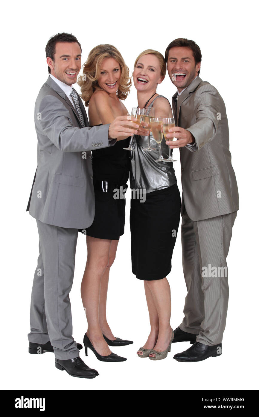 Two couples celebrating with champagne Stock Photo - Alamy