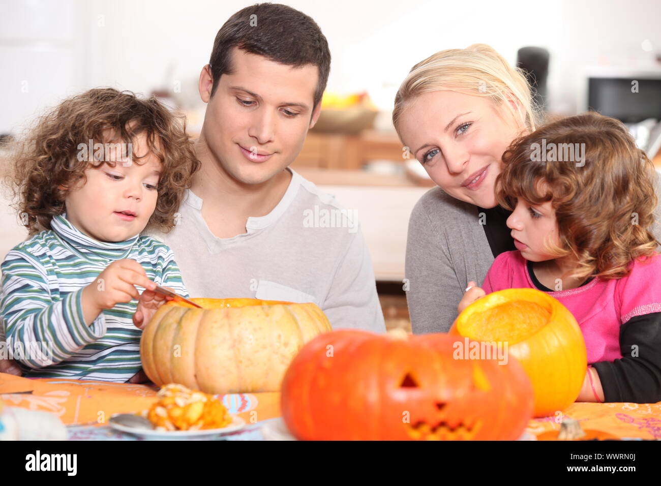 two parents and their two children celebrating Halloween Stock Photo ...