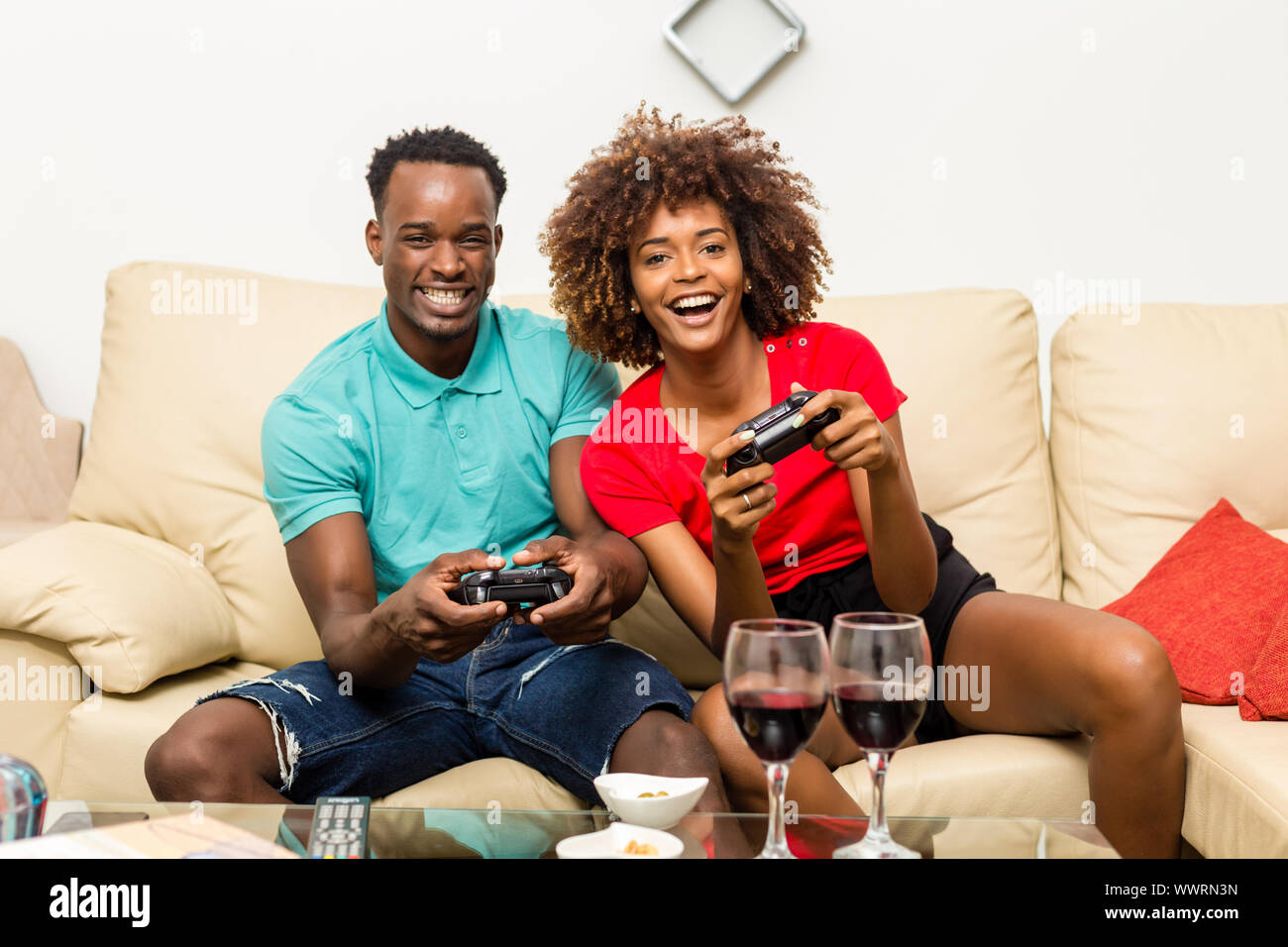 Black African American couple having fun playing video games Stock ...