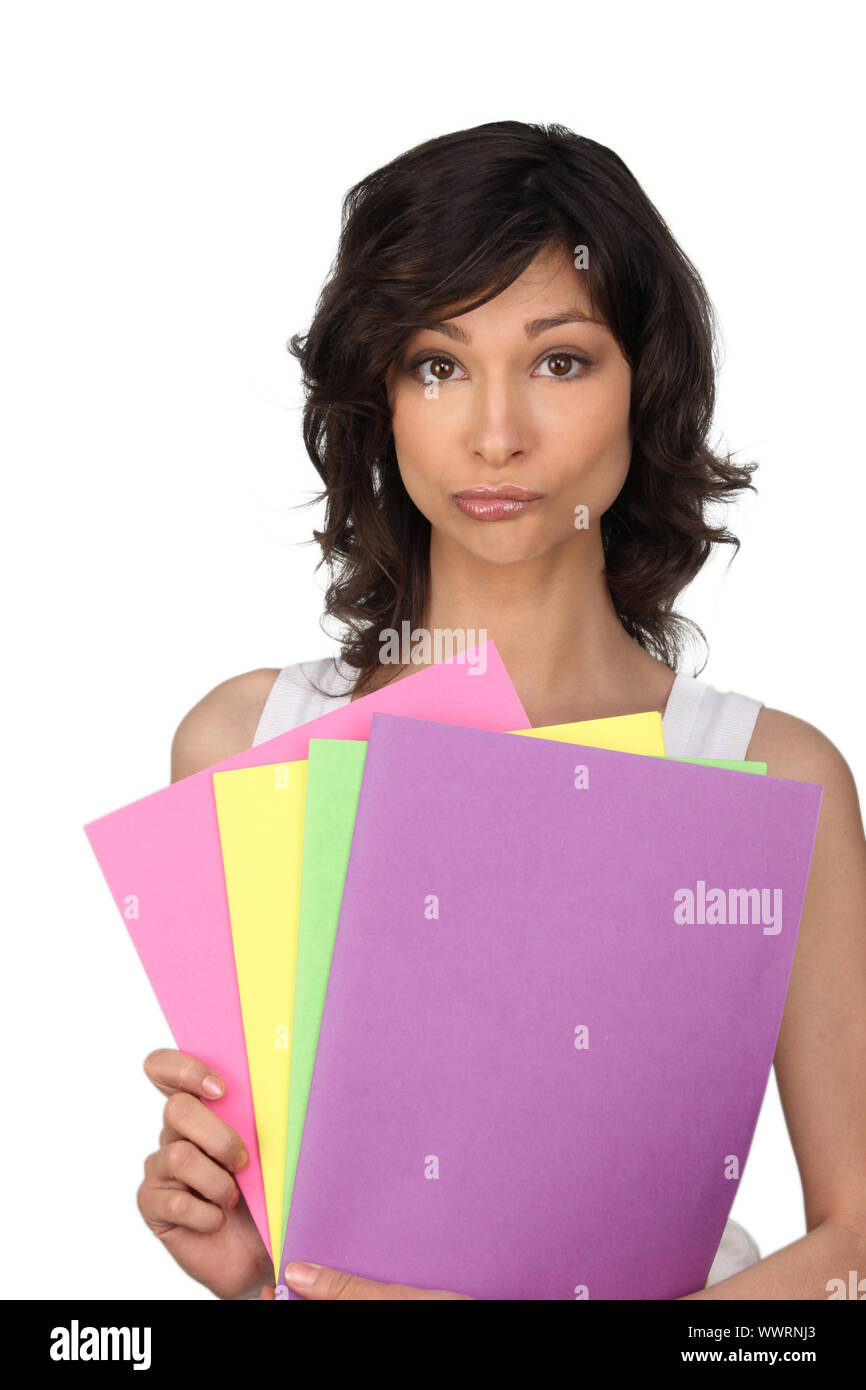 Woman perplexed at her office files Stock Photo - Alamy