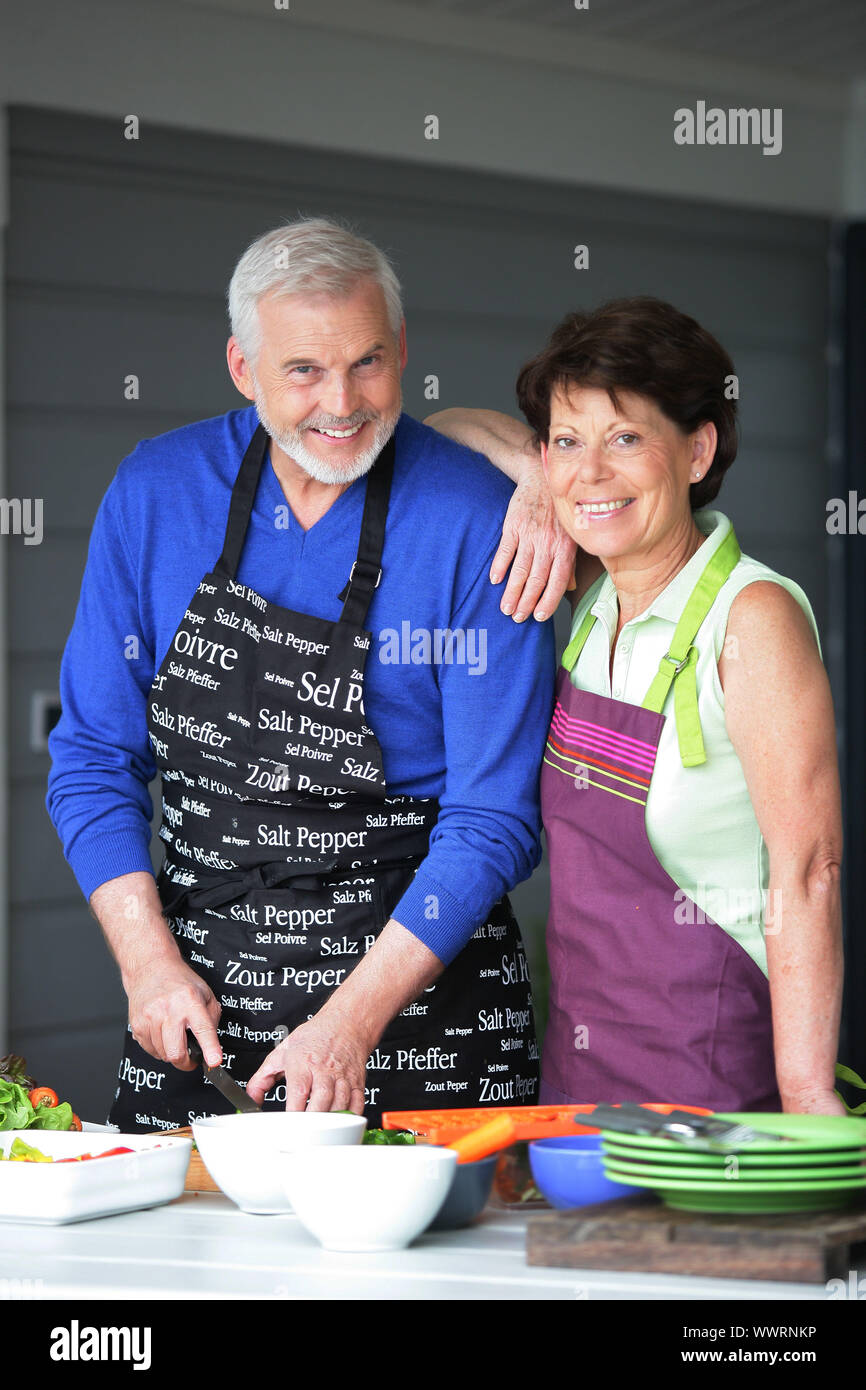 Married couple cooking together on the terrace Stock Photo - Alamy