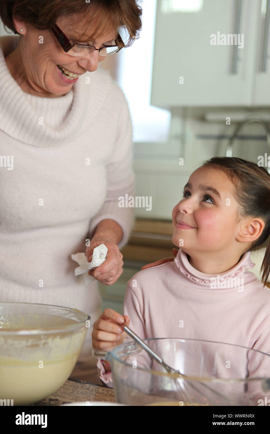 Little girl cooking with grandma Stock Photo - Alamy
