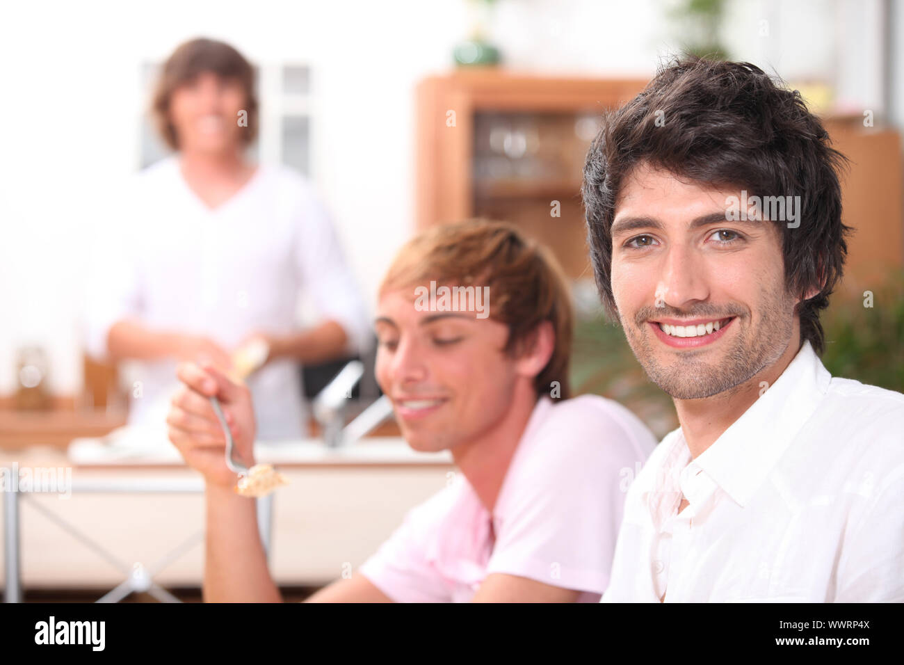 Kids eating in the kitchen Stock Photo - Alamy