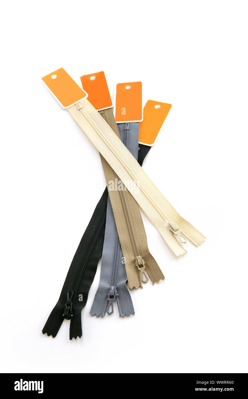Four zips of different color Stock Photo - Alamy