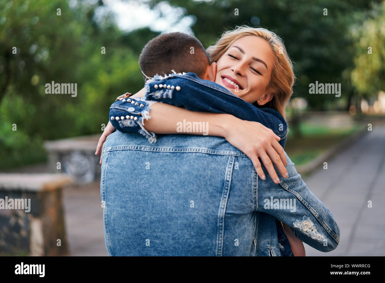 Two lovers hugging each other hi-res stock photography and images - Alamy