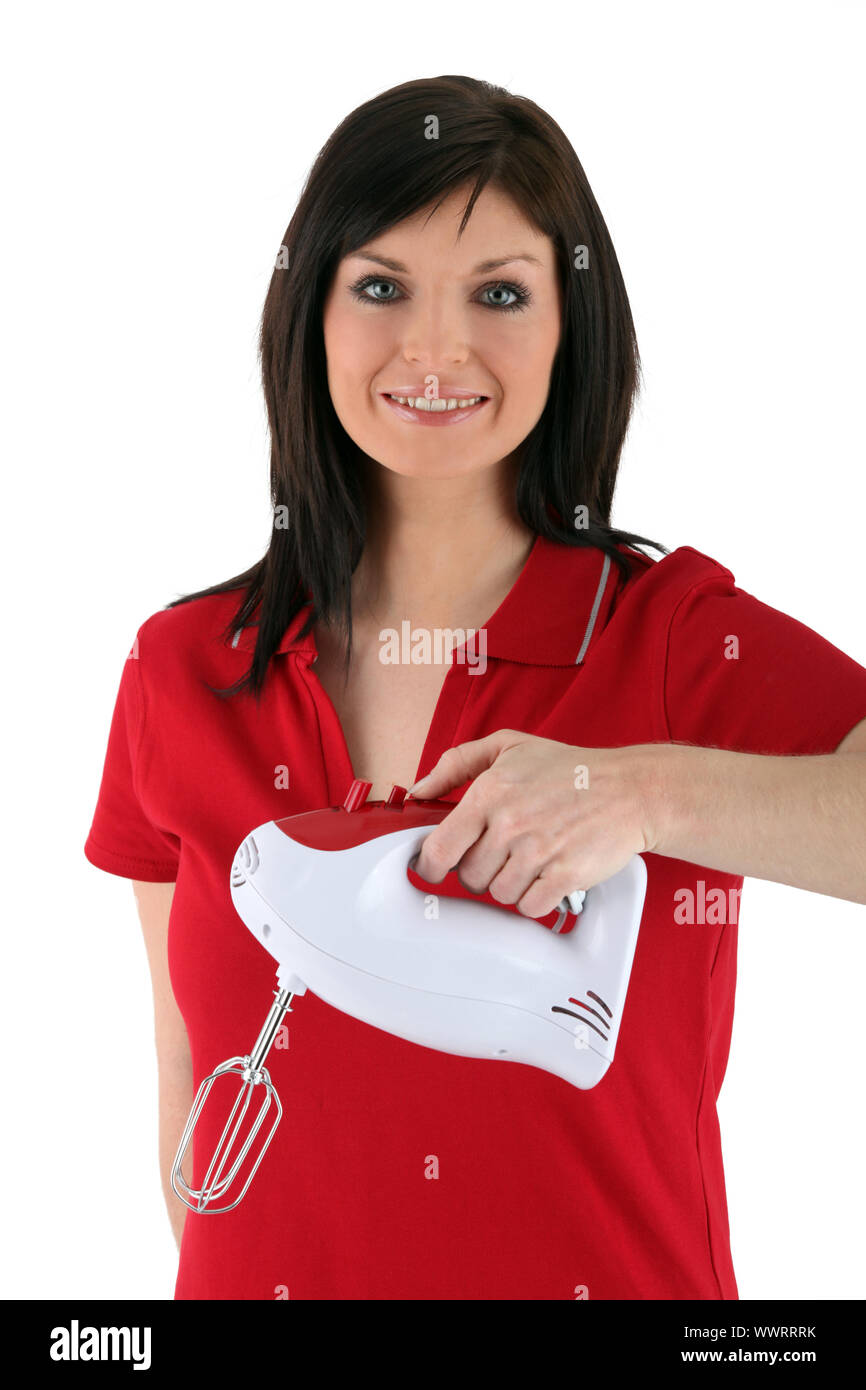 Smiling woman holding electric whip Stock Photo - Alamy