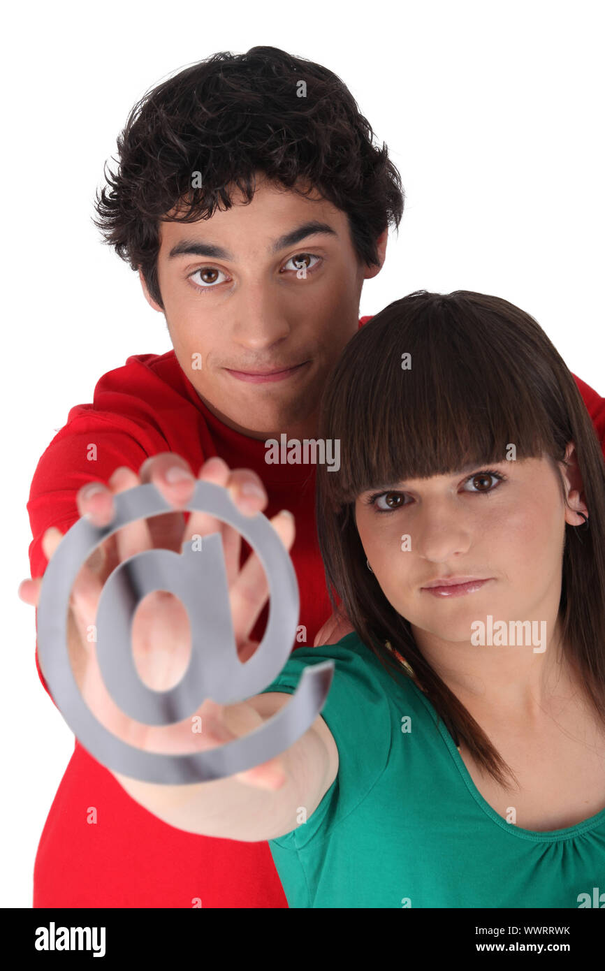 Couple holding metallic at symbol Stock Photo - Alamy