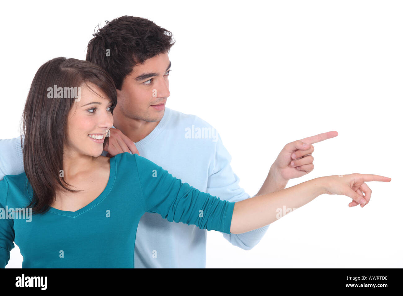 Couple stood together pointing into the distance Stock Photo - Alamy
