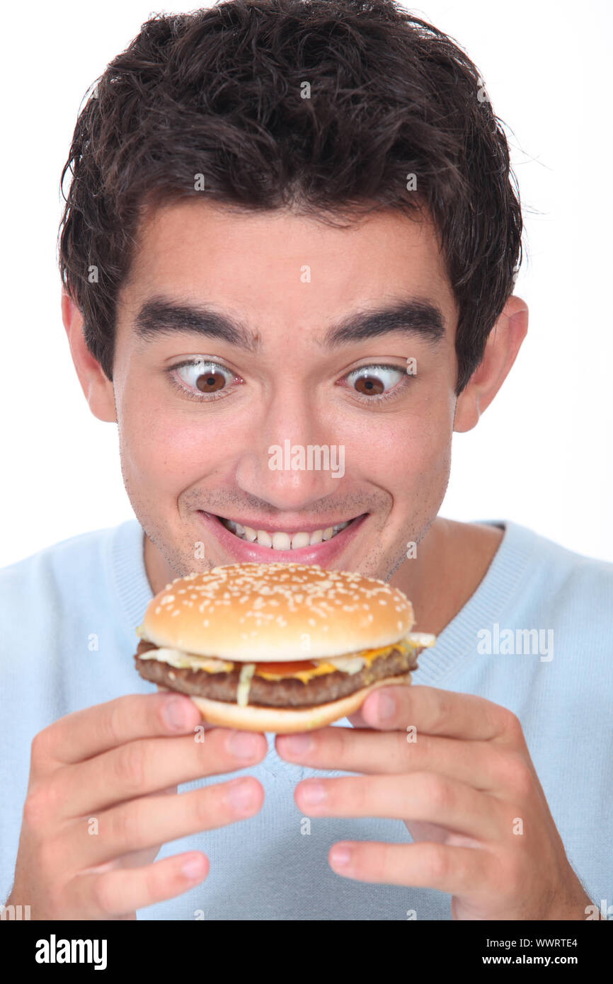 Man holding cheeseburger Stock Photo - Alamy