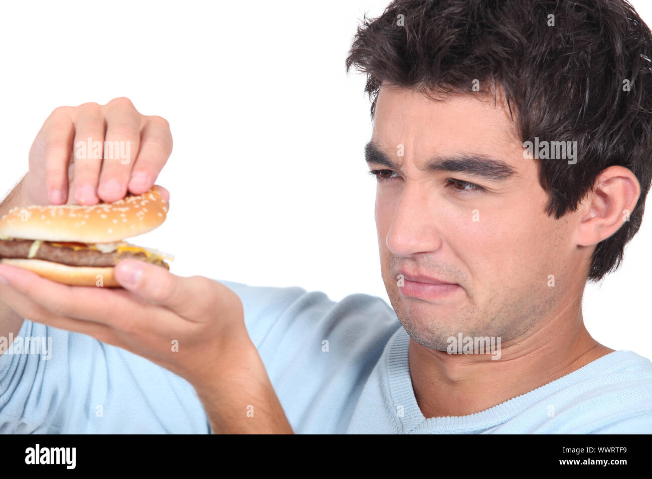Man holding cheeseburger Stock Photo - Alamy