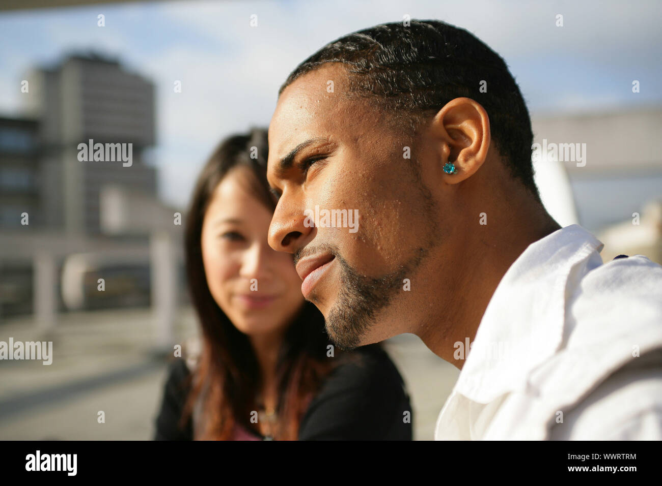 Woman trying to talk with her unresponsive boyfriend Stock Photo - Alamy