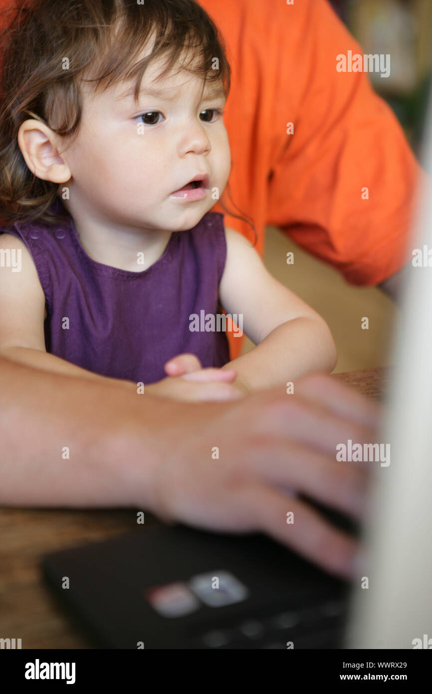 Child sitting at a laptop Stock Photo - Alamy