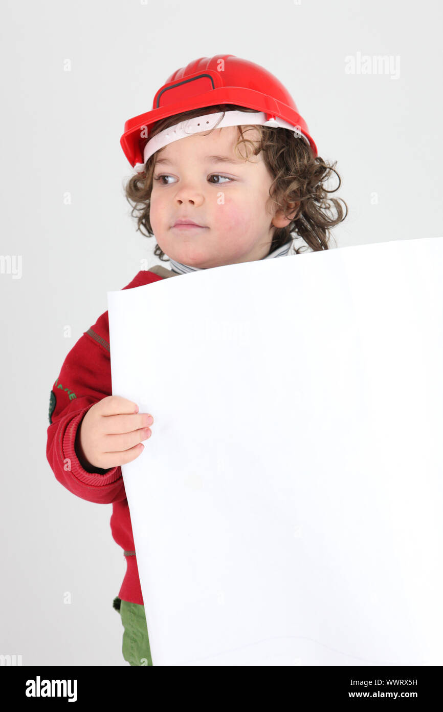 Little boy dressed as manual worker holding poster Stock Photo - Alamy