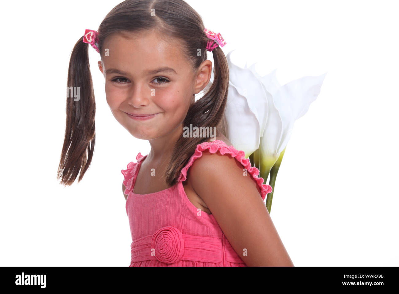 Girl hiding flowers behind her back Stock Photo - Alamy