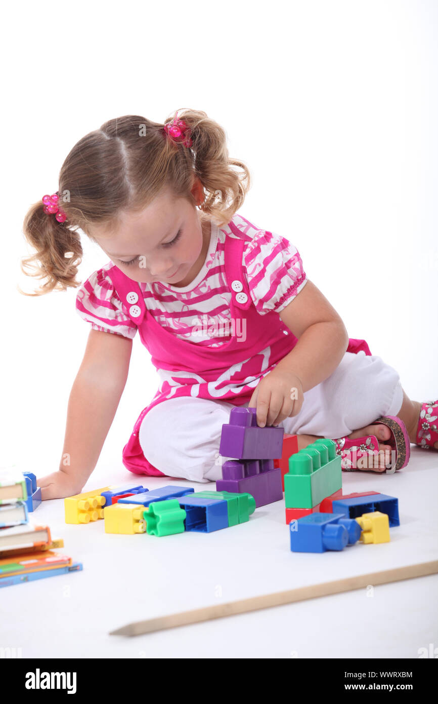 Little girl playing with building blocks Stock Photo - Alamy
