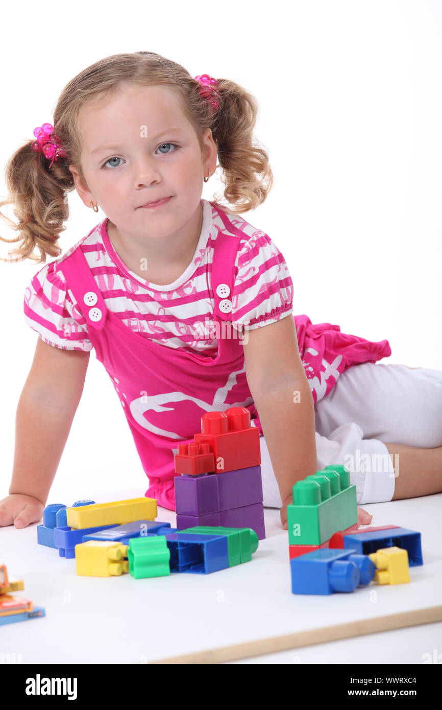 Young girl playing with blocks Stock Photo - Alamy