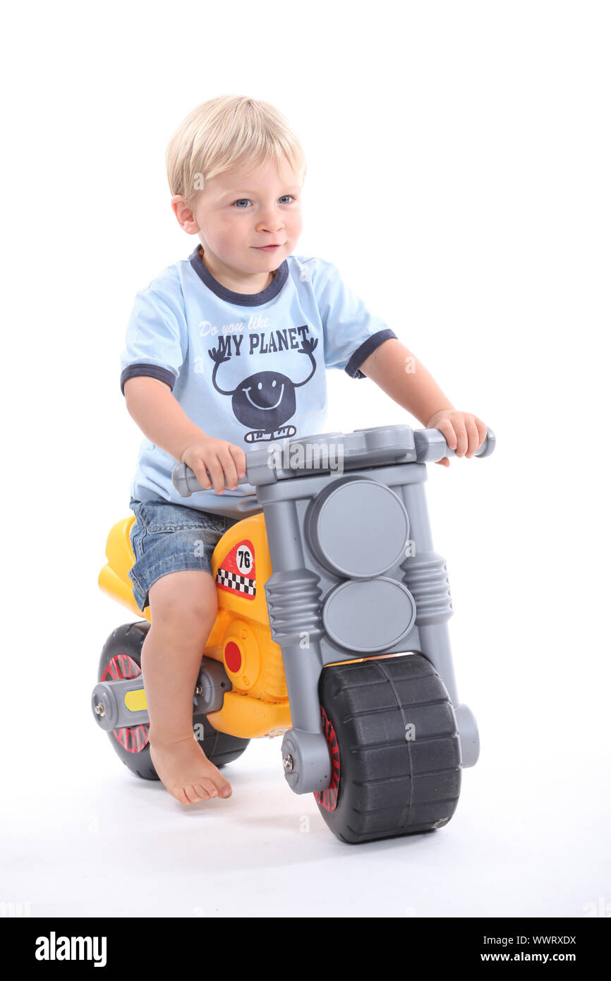 Young boy on a toy bike Stock Photo - Alamy
