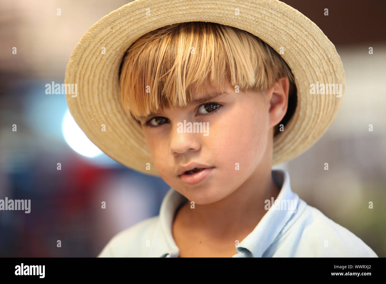 Blond boy with straw hat Stock Photo - Alamy