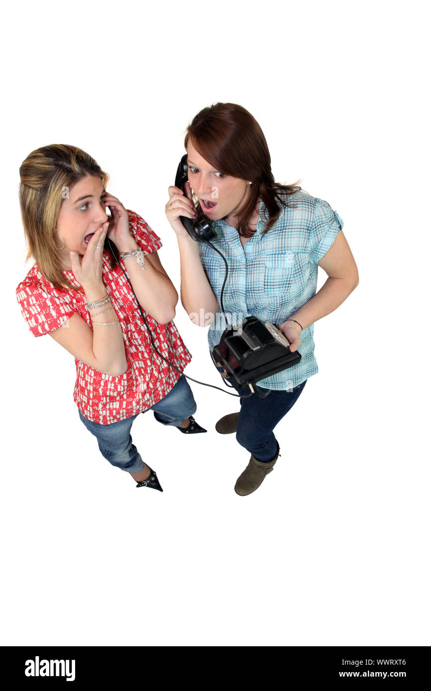 Girls gossiping on the phone Stock Photo - Alamy