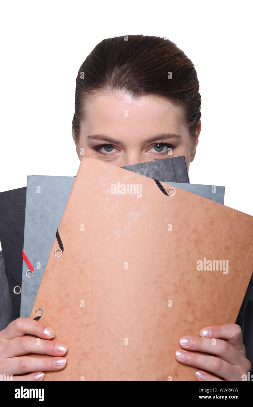 Businesswoman hiding face behind folders Stock Photo - Alamy