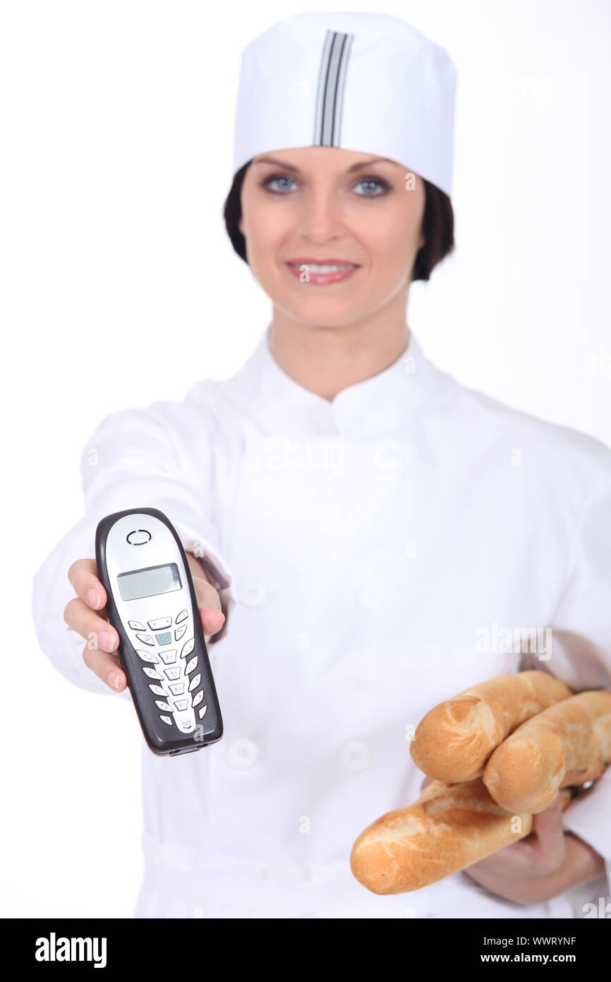 Female baker showing phone Stock Photo - Alamy